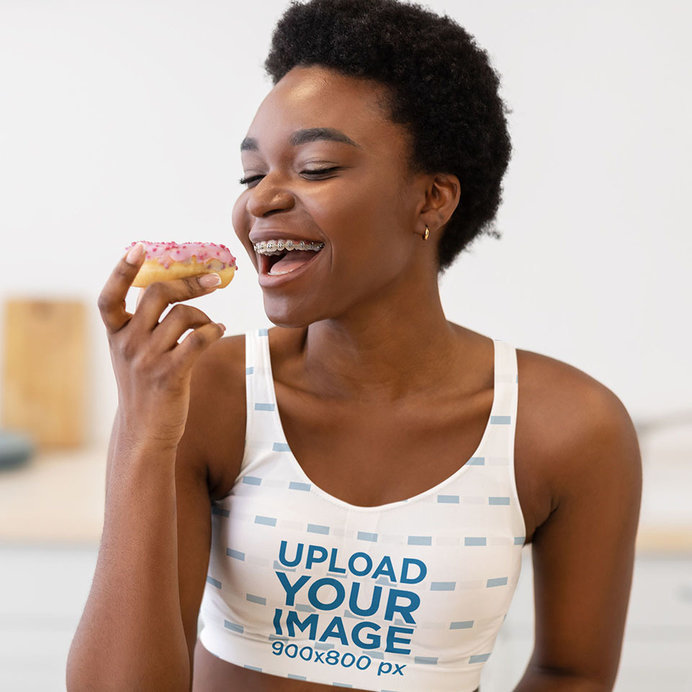 Placeit - Sports Bra Mockup of a Woman Eating a Donut