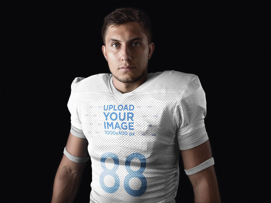 Placeit - Custom Football Uniform Designer - Man Standing in Black Room