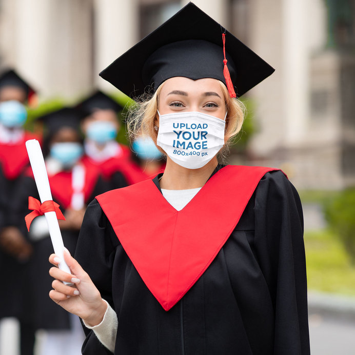 Placeit - Face Mask Mockup of a Happy Woman Holding Her Graduate Diploma