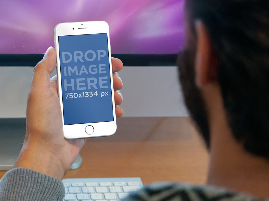 Placeit - Mockup of a White iPhone Being Used at Work by a Man