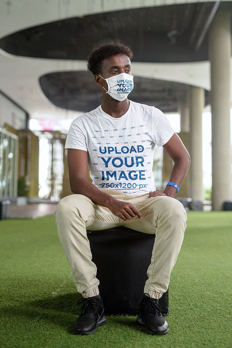 Placeit - Mockup of a Man Sitting on a Stool While Wearing a Face Mask ...