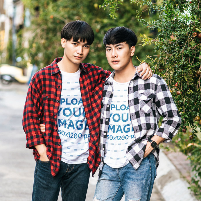 Placeit - T-Shirt Mockup Featuring Two Men Hugging in the Street