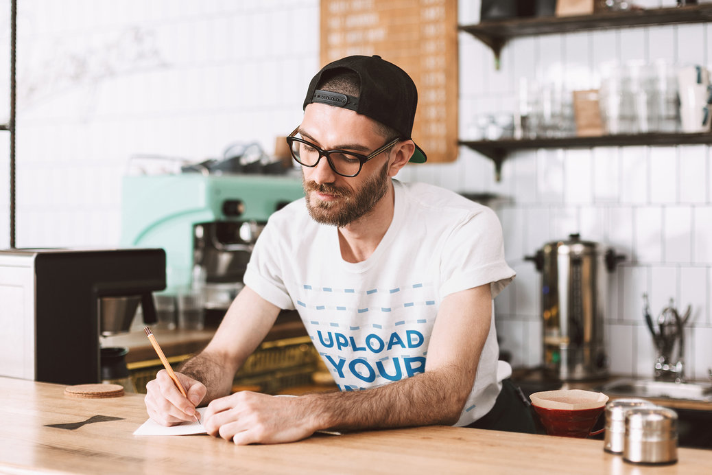 Placeit - T-Shirt Mockup of a Man Working at a Coffee Shop
