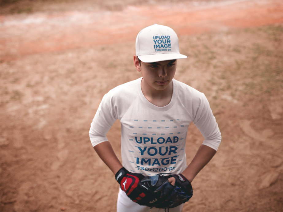 Placeit - Young Boy Wearing a Baseball Hat Mockup While at the Field