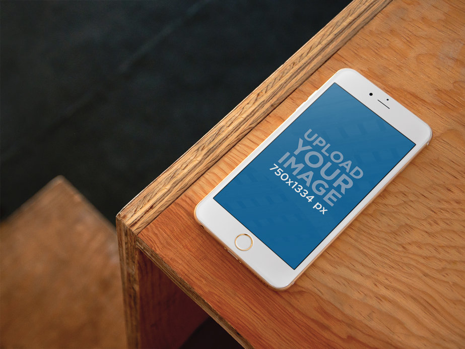 Placeit - iPhone 6 on a Wooden Desk