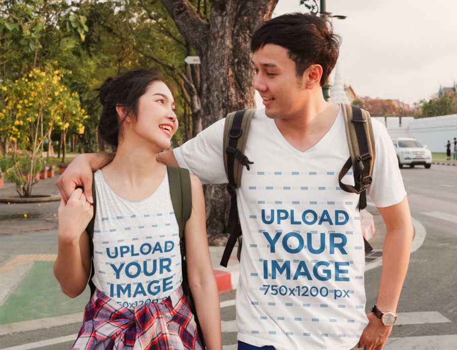 Placeit - Tank Top and T-Shirt Mockup of a Young Couple of Tourists Hugging
