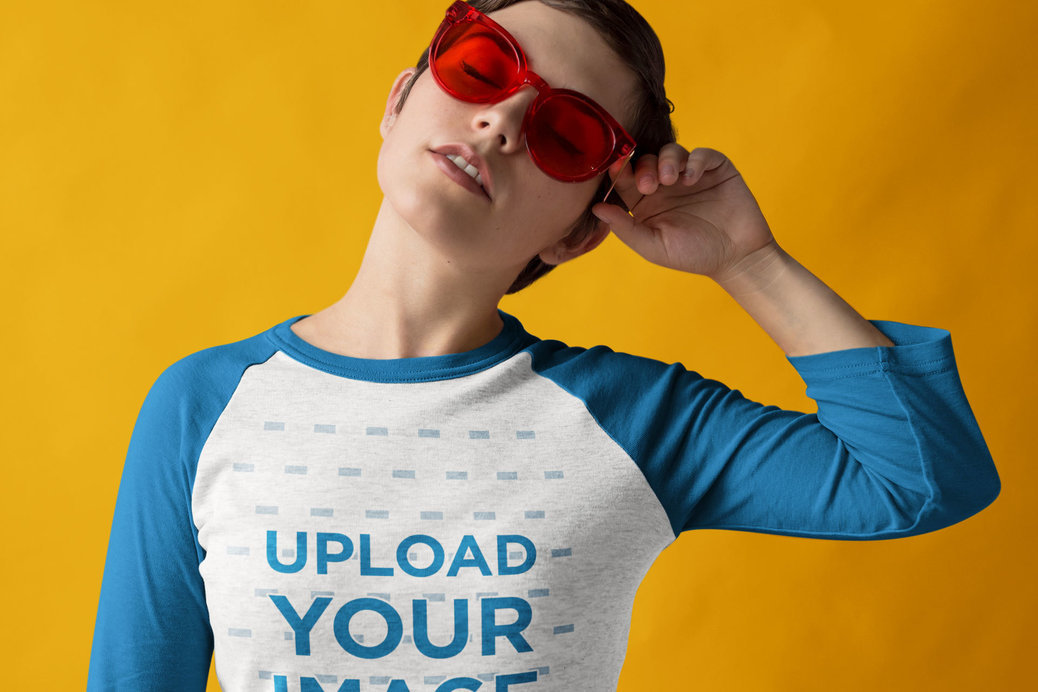 Placeit - Woman with Red Glasses Wearing a Heathered Raglan Tshirt Template