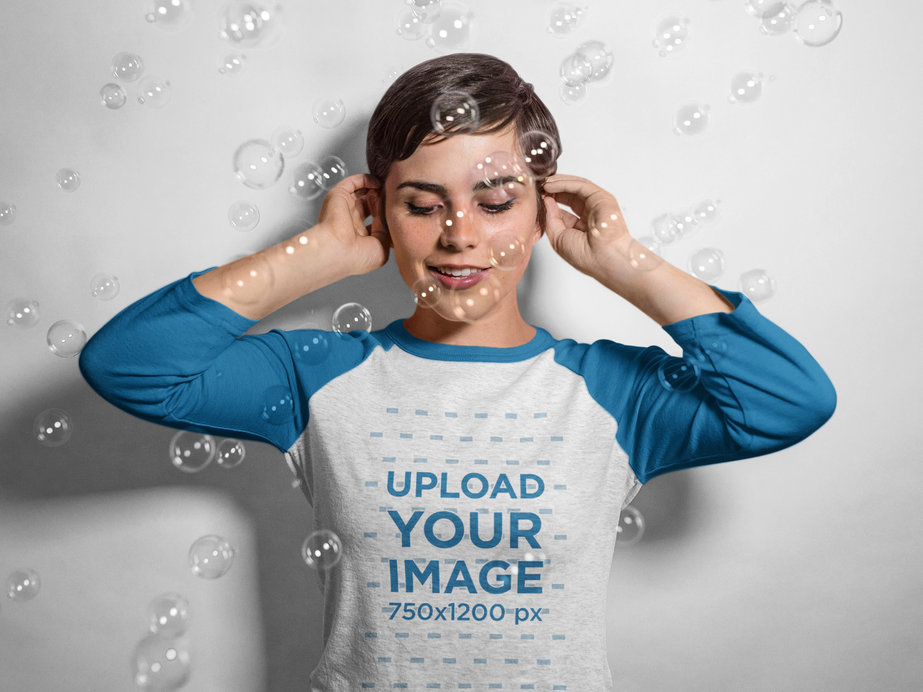 Placeit - Woman Wearing a Raglan Tee Template in a Room with Bubbles