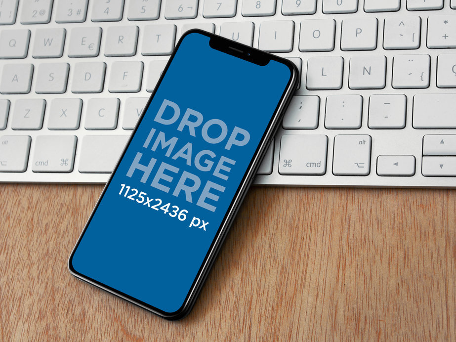 Placeit - Mockup of an iPhone 11 Pro Lying Over an Apple Keyboard