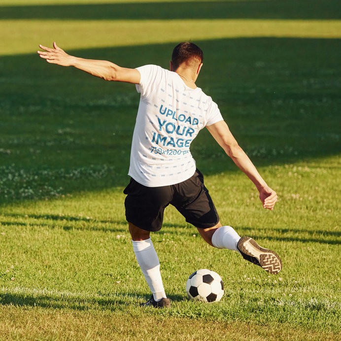 Placeit - Back-View T-Shirt Mockup of a Soccer Player Kicking a Ball
