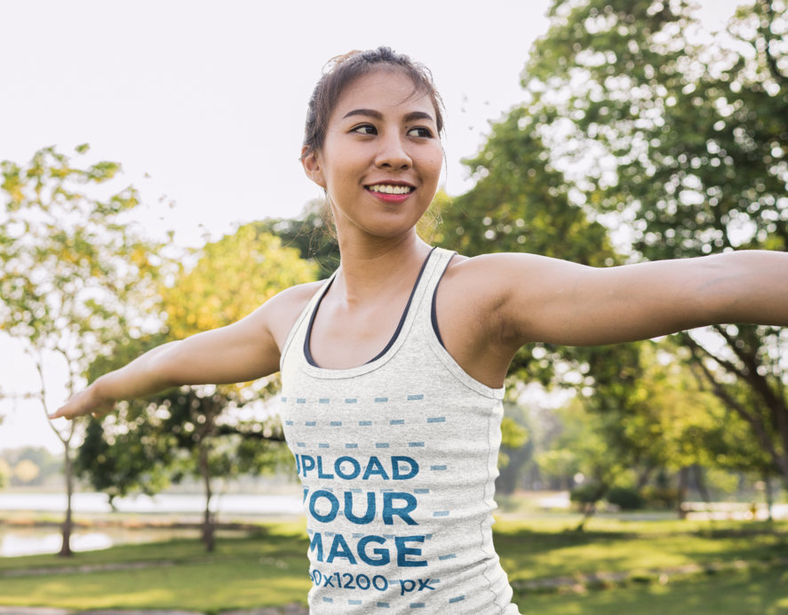 Placeit - Heathered Tank Top Mockup of a Woman Practicing Yoga by a Lake