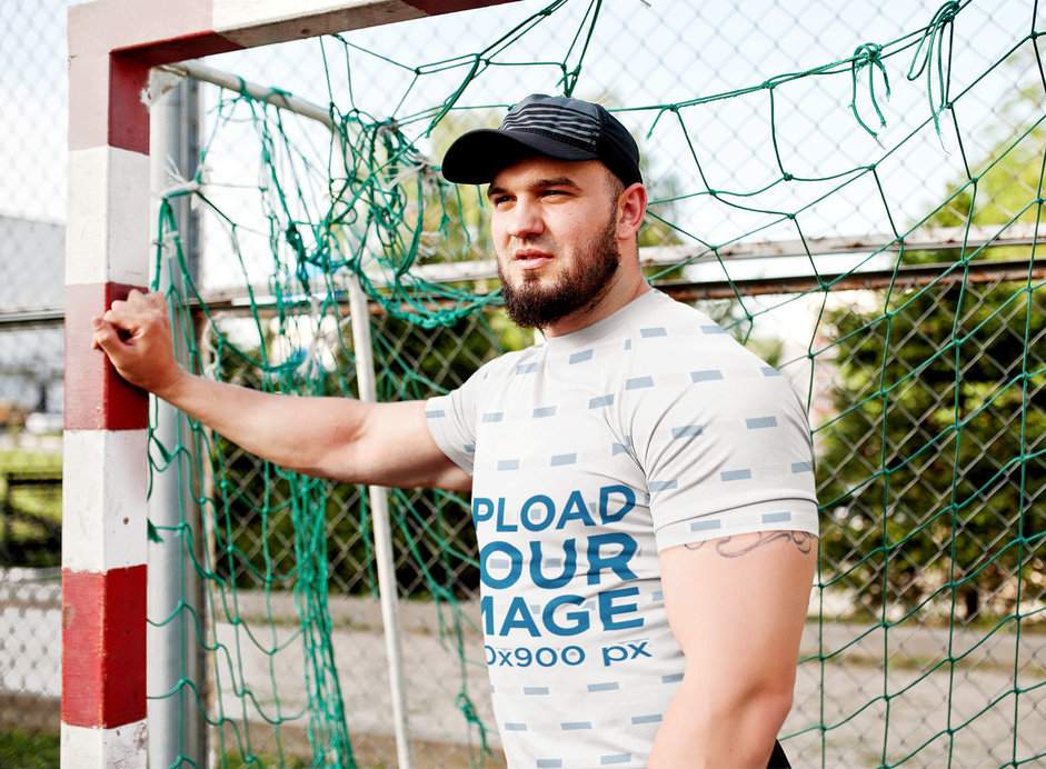 Placeit - Mockup of a Muscular Man Wearing a T-Shirt in a Soccer Field