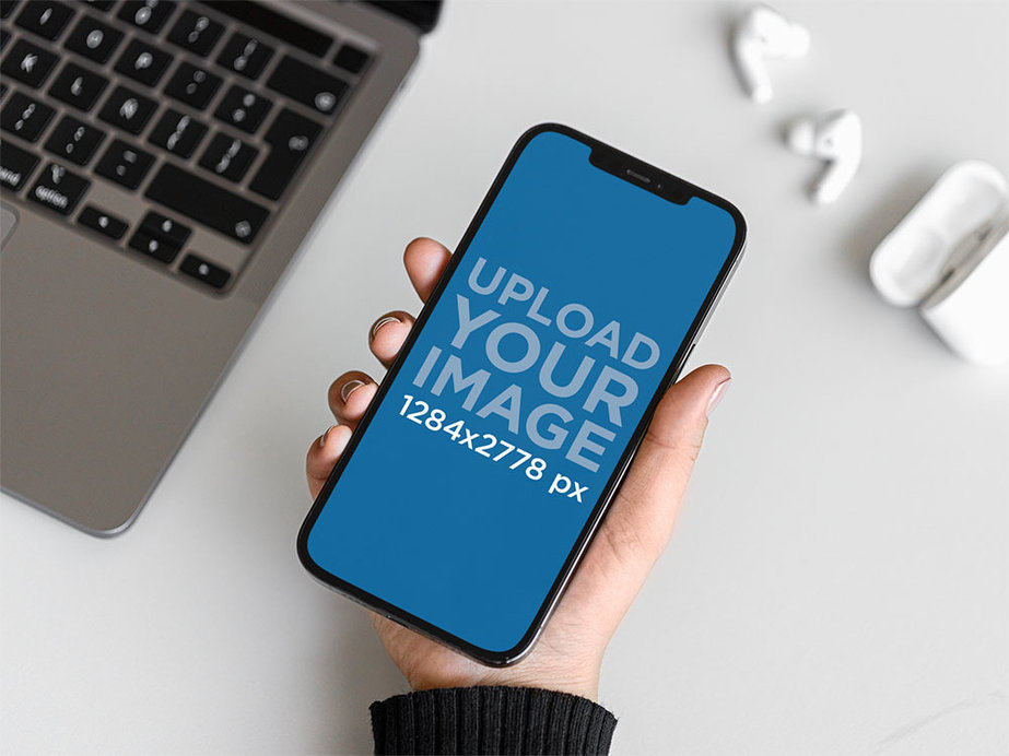 Placeit - Mockup of a Woman Taking Her iPhone 12 Pro Max From Her Desk