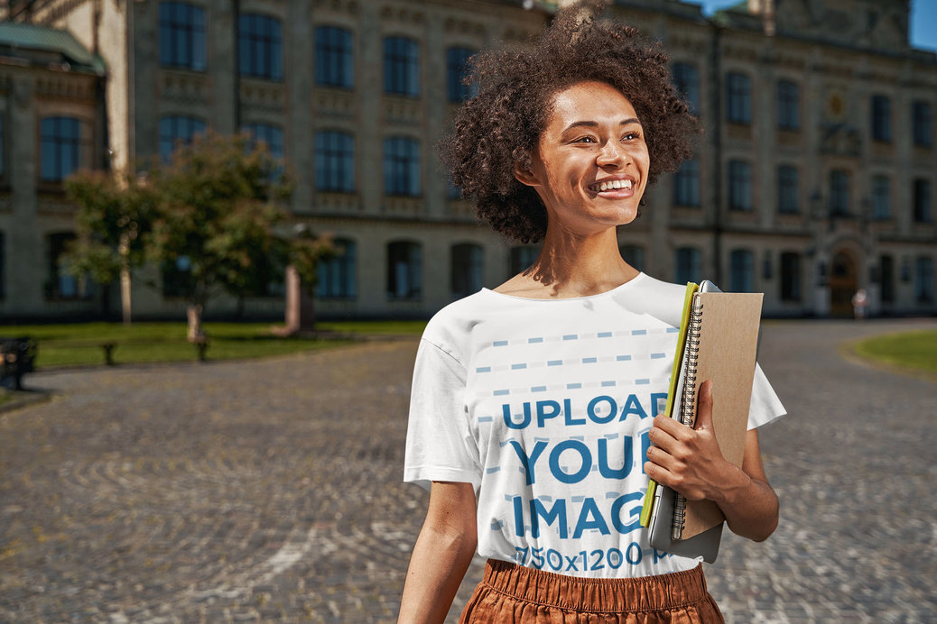 Placeit - T-Shirt Mockup of a Happy College Student Holding Her Books