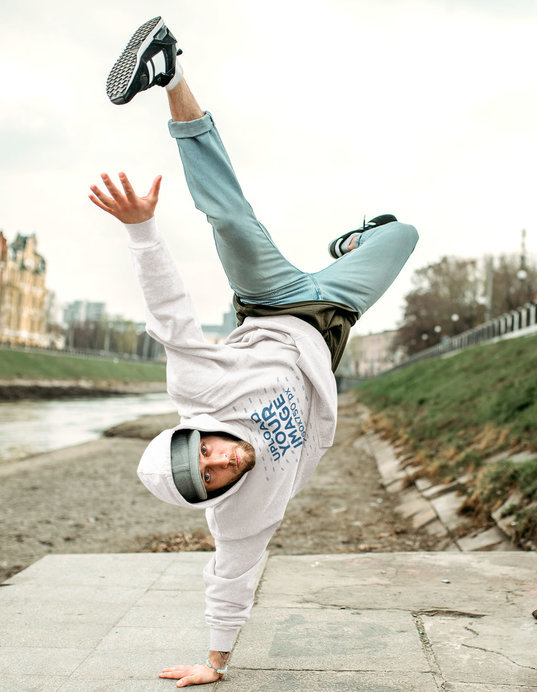 Placeit - Hoodie Mockup of a Dancer Doing a One Arm Handstand