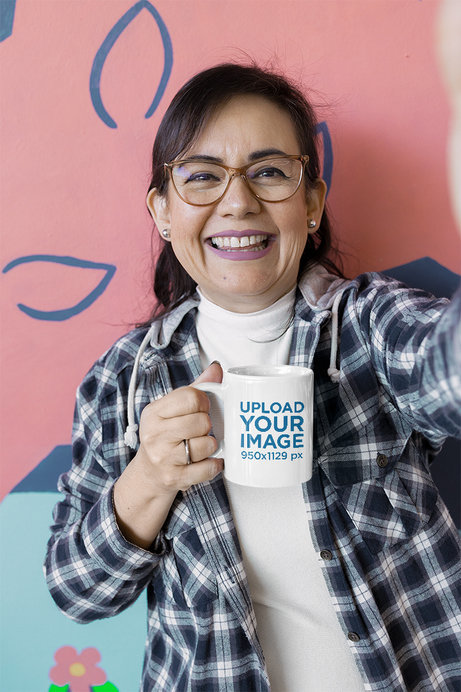 Placeit - Mockup of a Happy Woman Taking a Selfie Holding an 11 oz Mug