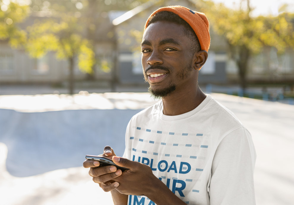 Placeit - T-Shirt Mockup Featuring a Happy Man Checking His Phone at a ...
