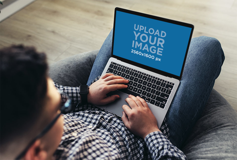 Placeit - MacBook Mockup Featuring a Man Working Remotely