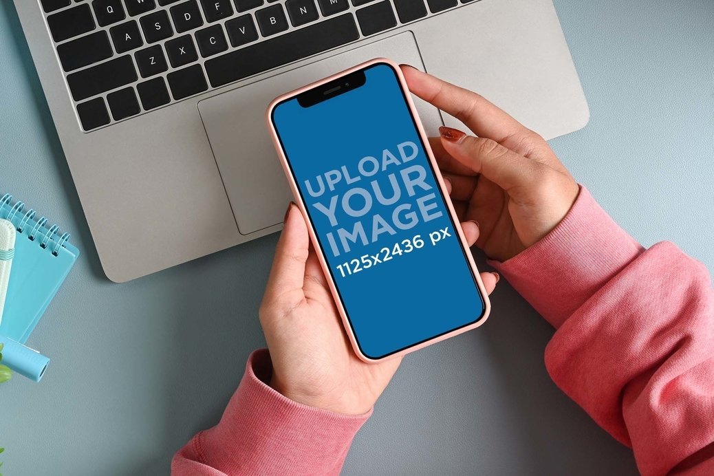 Placeit - Mockup of a Woman Holding an iPhone 13 at Work