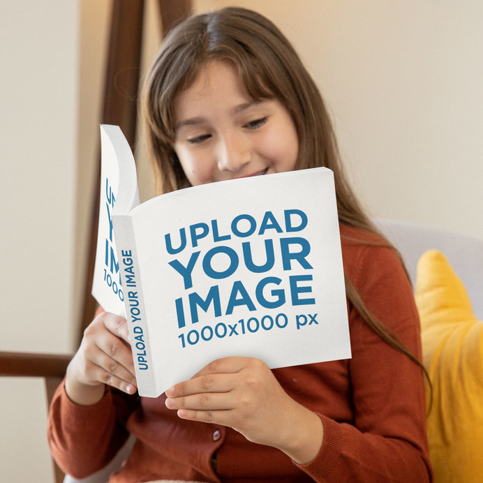 Placeit - Mockup of a Happy Girl Reading a Square Book in a Living Room