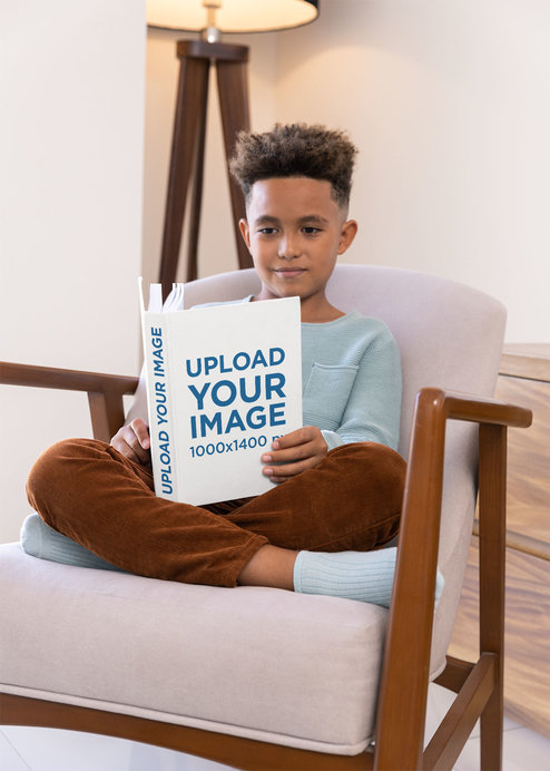 Placeit - Mockup of a Relaxed Kid Reading a Book in the Living Room