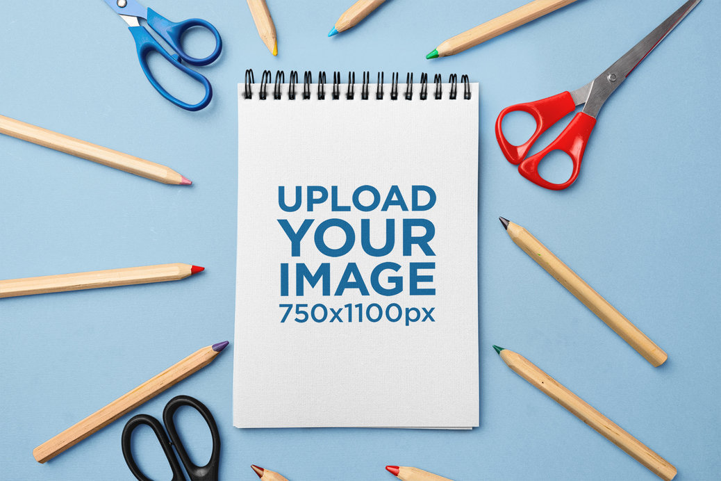 Placeit - Mockup of a Spiral Notebook Featuring School Scissors and Pencils