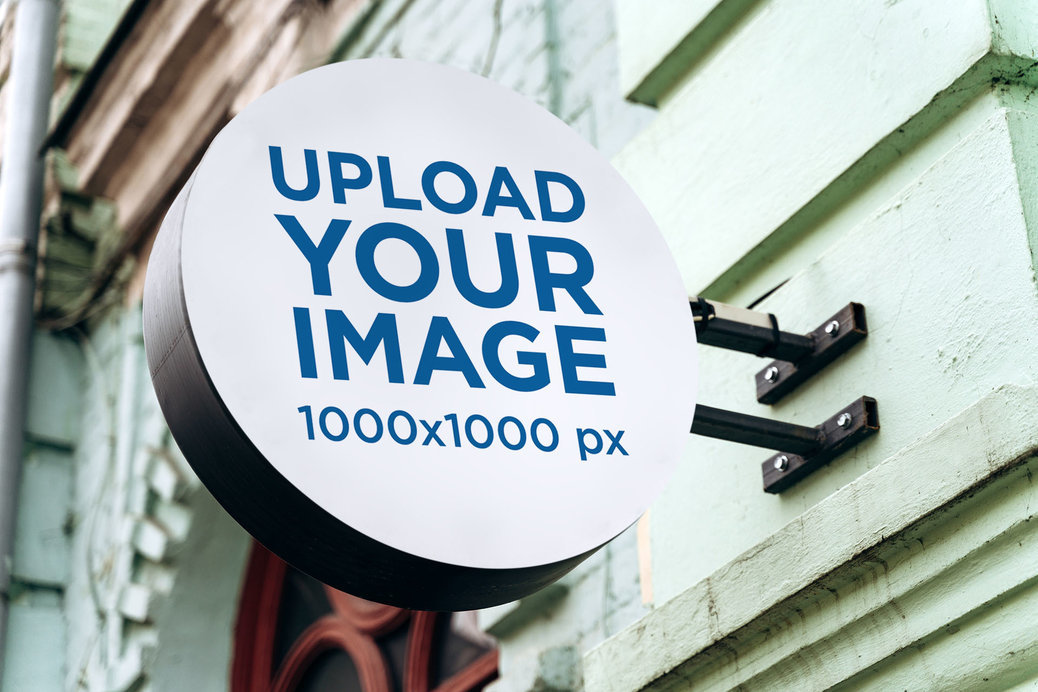 Placeit - Mockup of a Circular Sign Placed Outside a Shop