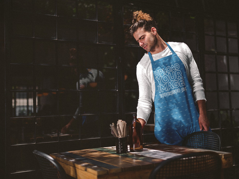 Placeit - Man Wearing an Apron Mockup Cleaning the Table