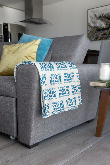 Placeit - Sublimated Throw Blanket Mockup Placed over a Couch Arm Rest