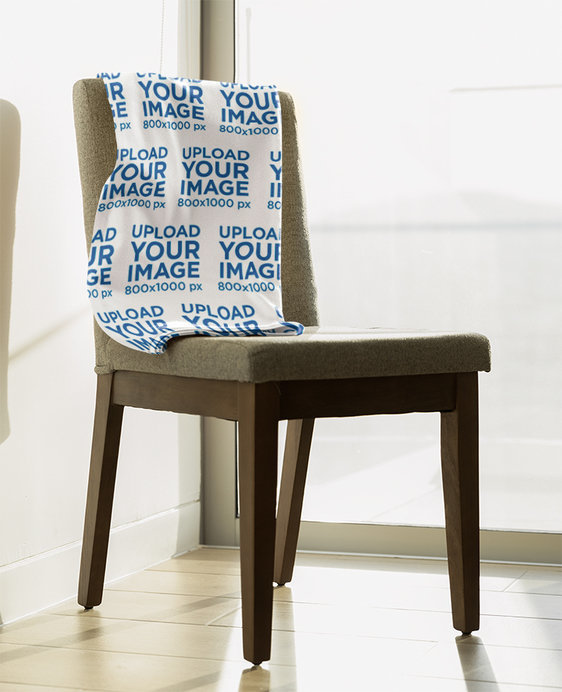 Placeit - Mockup of a Sublimated Throw Blanket Placed over a Chair