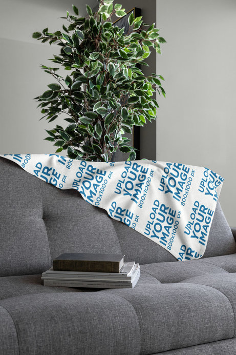 Placeit - Throw Blanket Mockup Featuring a Couch with Books