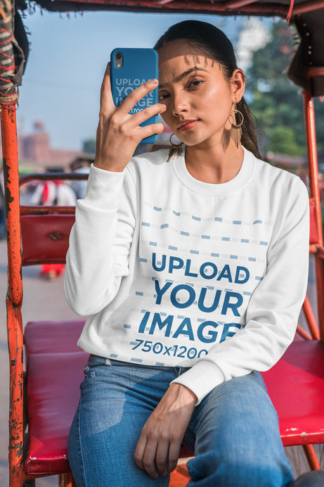 Placeit - Phone Case Mockup of a Woman in a Sweatshirt Taking a Selfie
