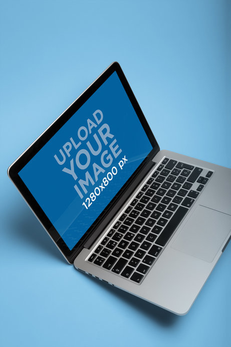Placeit - Portrait Shot of a MacBook Mockup on a Solid Color Surface