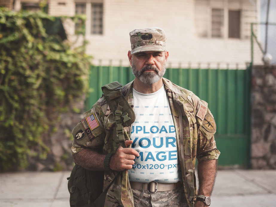 Placeit - T-Shirt Mockup Featuring a Soldier in Army Gear on the Street