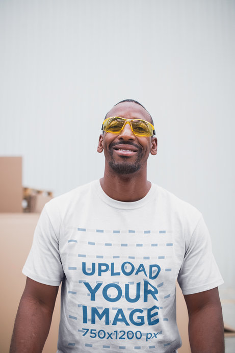 Placeit - Smiling Warehouse Worker Wearing Safety Goggles and a T-Shirt ...