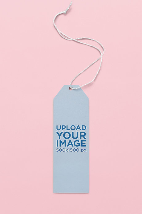 Placeit - Mockup of a Brand Tag With a Thread Lying on a Colored Surface