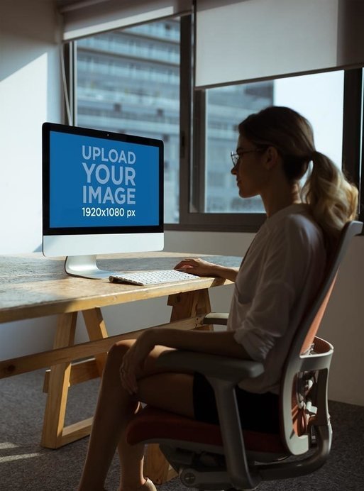 Placeit - Woman Working on her iMac Mockup Beside the Window in a Big ...