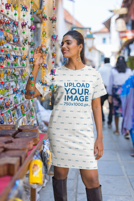 Placeit - T-Shirt Dress Mockup of a Woman Posing by a Street Souvenir Shop