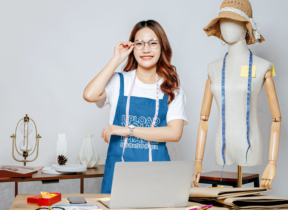Placeit - Apron Mockup of a Fashion Designer Posing at a Workshop