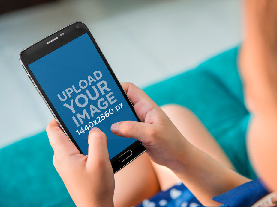 Placeit - Mockup of a Girl Using an Android Phone in a Vertical Position
