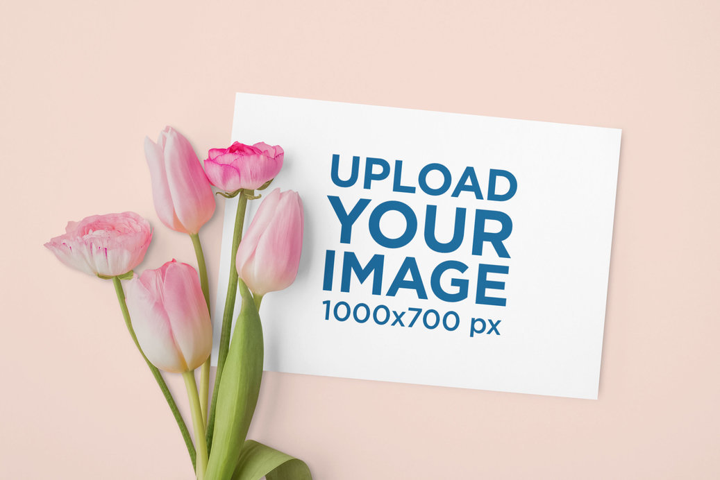 Placeit - Mockup of a Wedding Program Placed Next to Pink Flowers