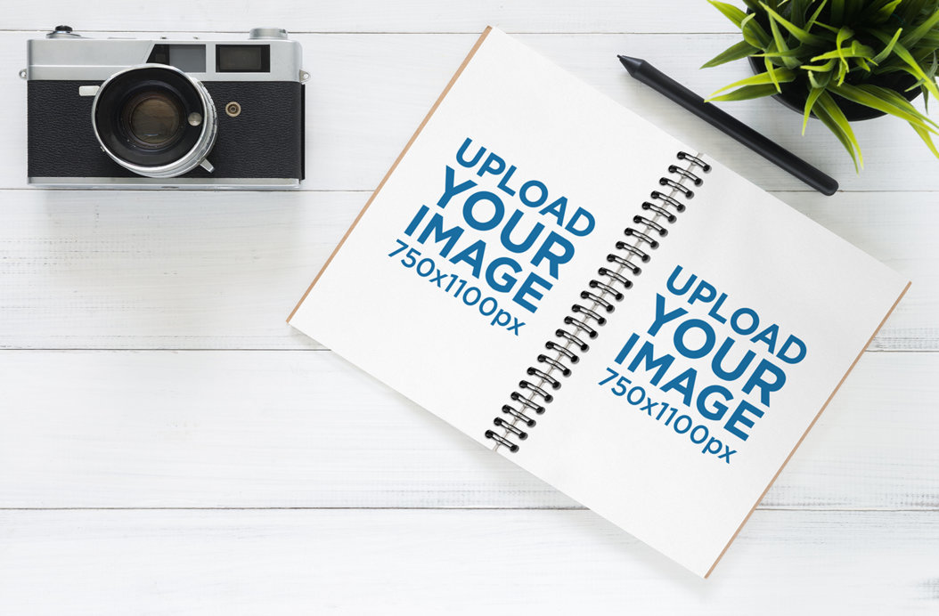 Placeit - Notebook Mockup Featuring a Camera and a Plant