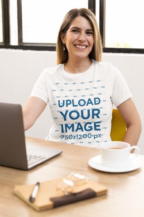 Placeit - Mockup of a Smiling Woman Wearing a Bella Canvas Tee at an Office