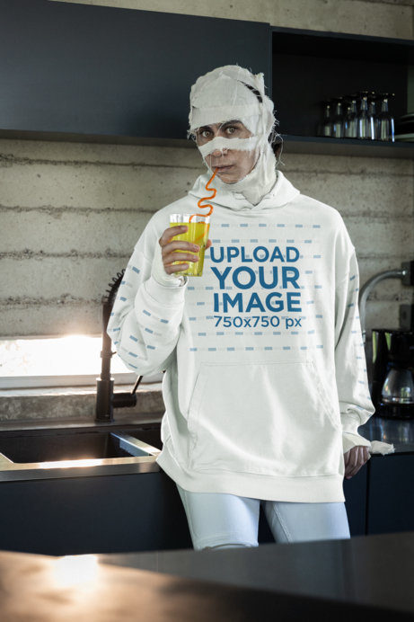 Placeit - Oversized Hoodie Mockup of a Mummy Drinking Orange Juice