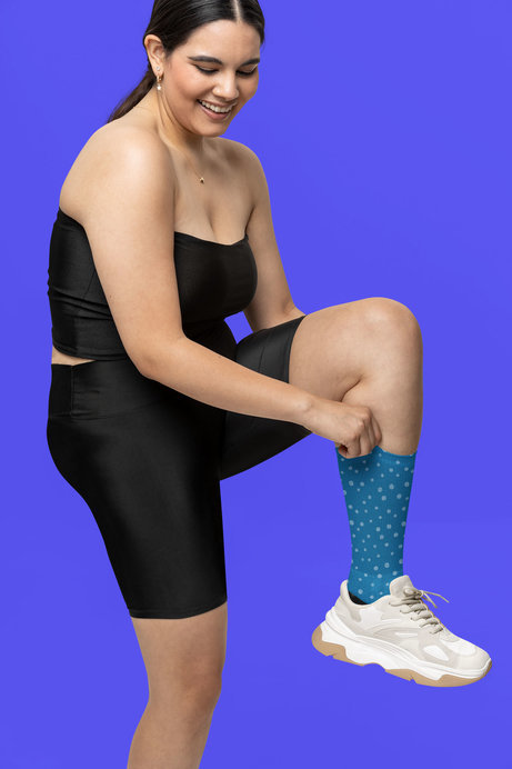 Placeit - Mockup of a Cheerful Woman Pulling a Sublimated Sock