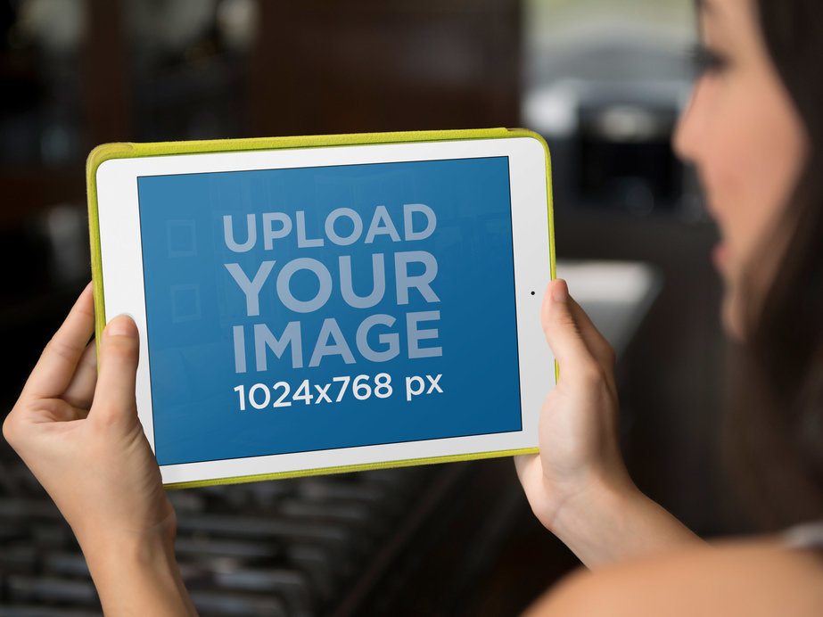 Placeit - iPad Mockup of Woman Holding A White iPad At Home