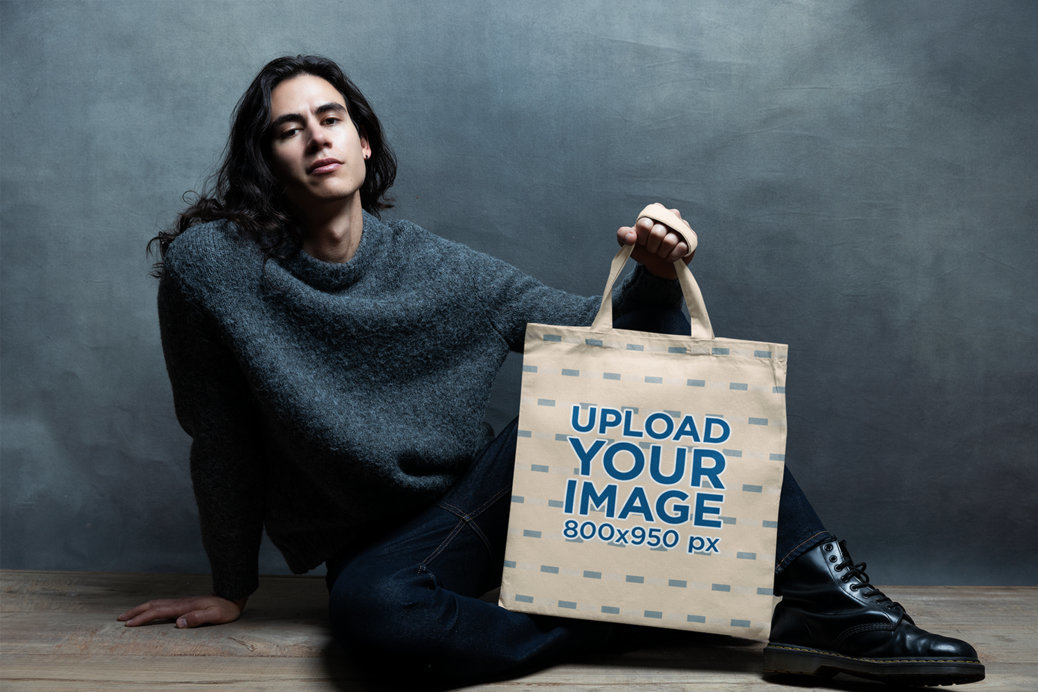 Placeit - Sublimated Tote Bag Mockup Featuring a Man Modeling in a Studio