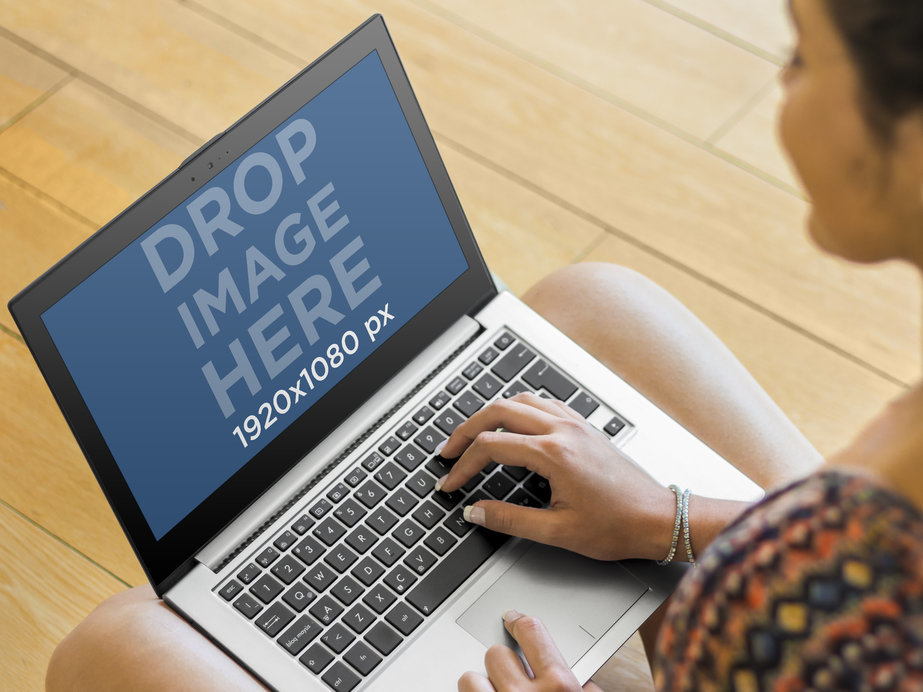 Placeit - Mockup Generator of Young Woman Using PC Laptop on Wooden Floor