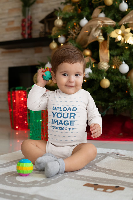 Placeit - Long-Sleeve Onesie Mockup Featuring a Cute Baby Playing by a ...