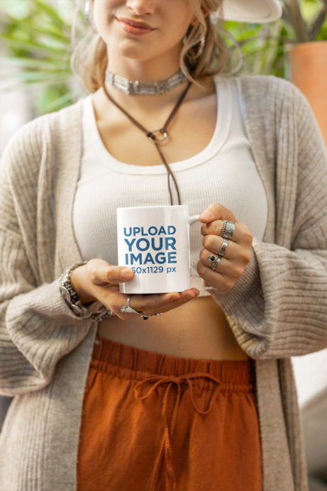 Placeit - 11 oz Coffee Mug Mockup of a Woman Wearing Boho-Styled Garments